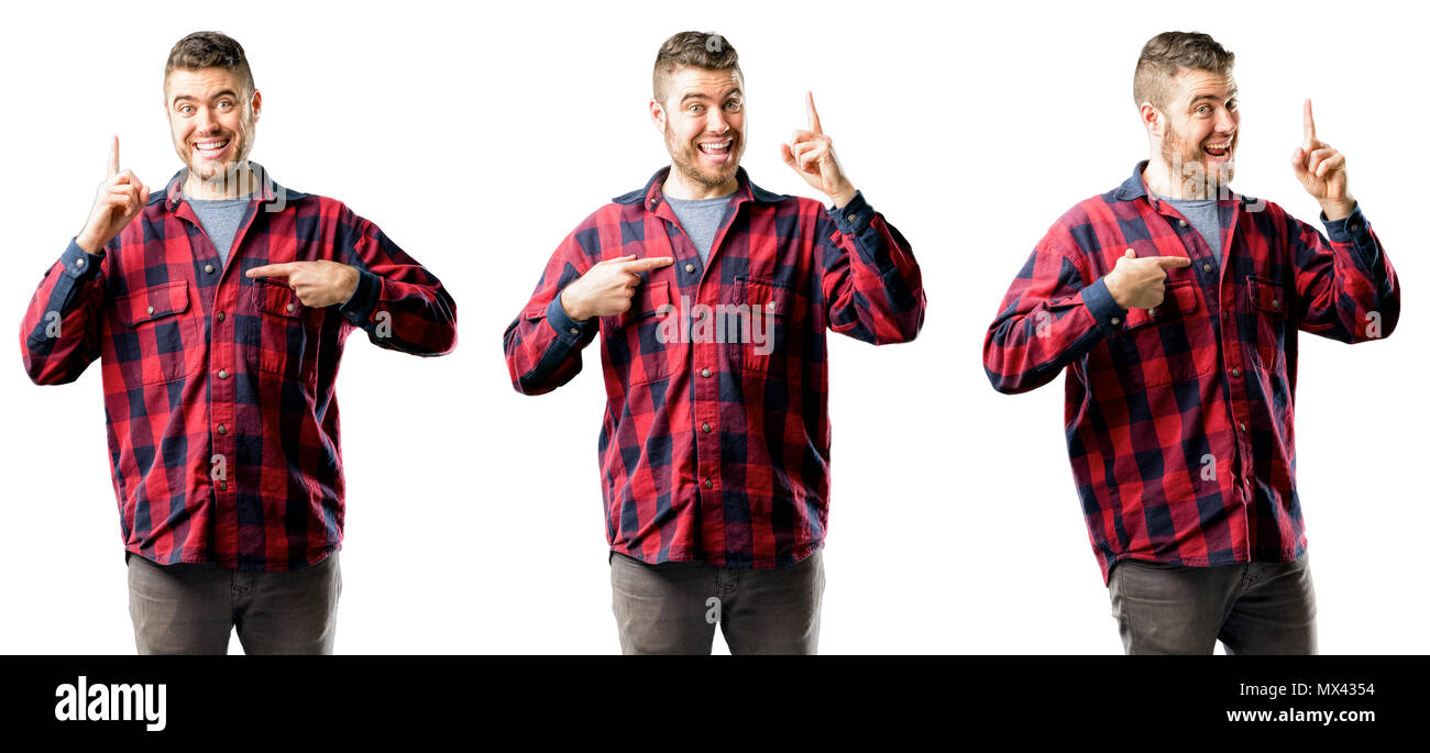 Young man happy and surprised cheering expressing wow gesture pointing ...