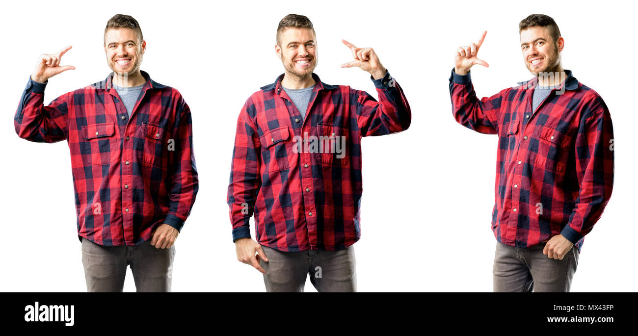 Young man holding something very tiny, size concept isolated over white ...