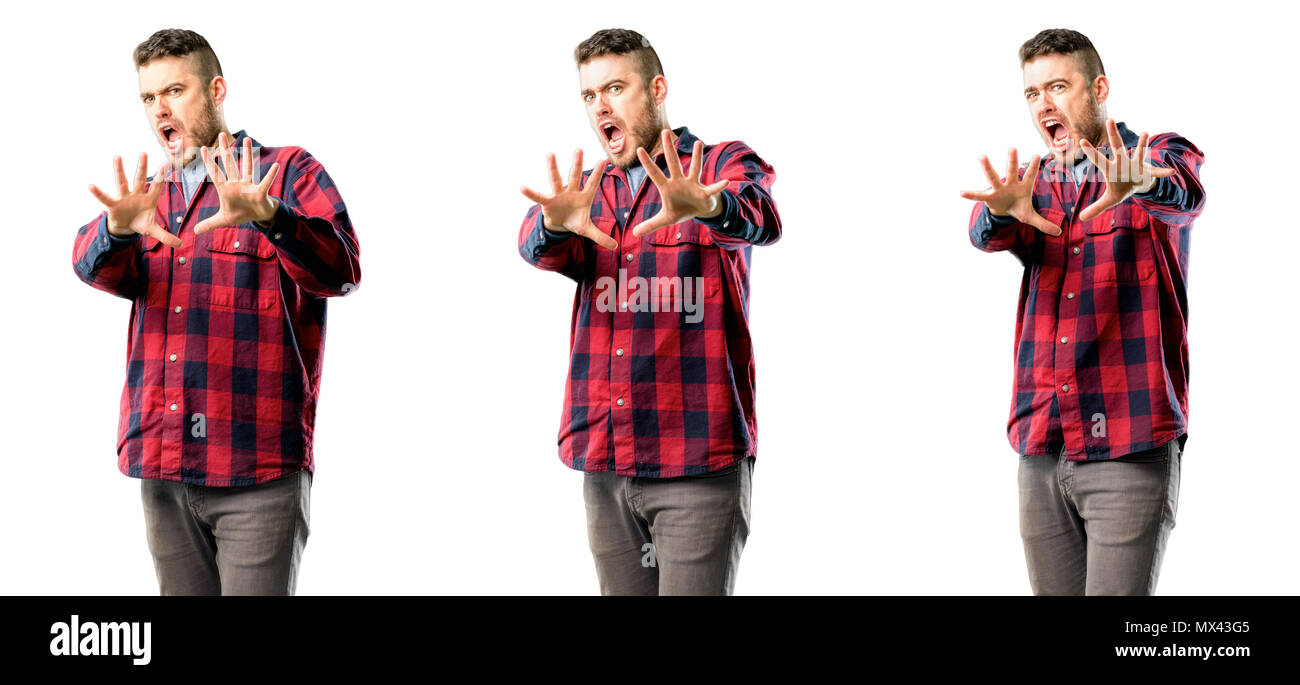 Young man disgusted and angry, keeping hands in stop gesture, as a ...