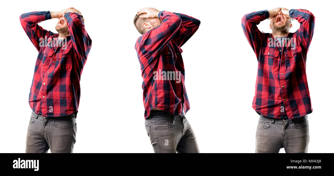 Young man stressful keeping hands on head, tired and frustrated ...