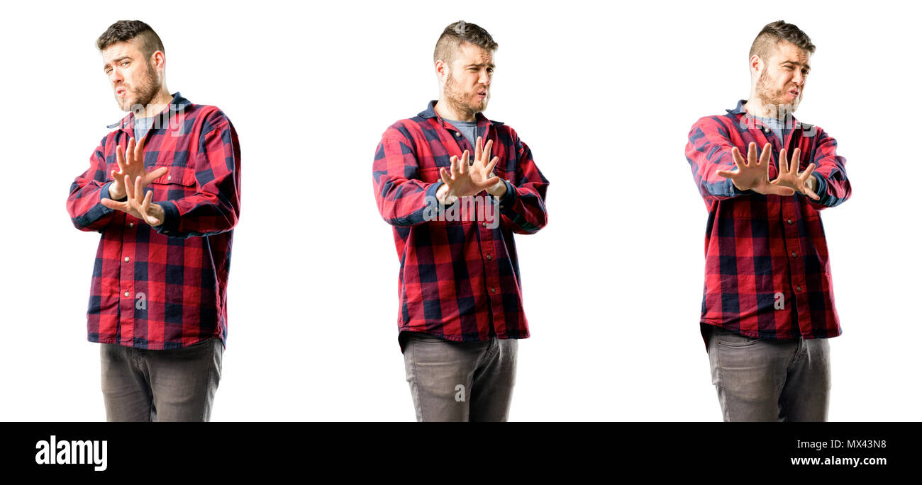 Young man disgusted and angry, keeping hands in stop gesture, as a ...