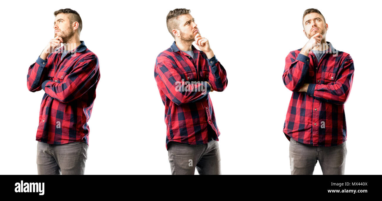 Young man thinking and looking up expressing doubt and wonder isolated ...