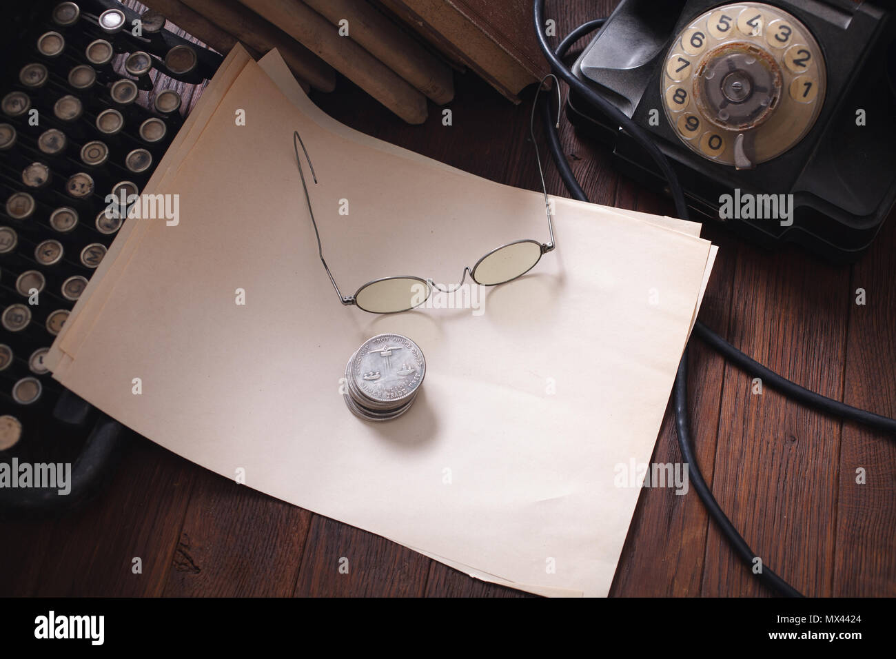 Old retro phone with vintage typewriter and a blank sheet of paper on ...