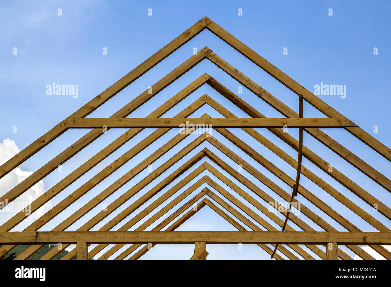 Close-up detail of wooden high steep roof framing under construction ...