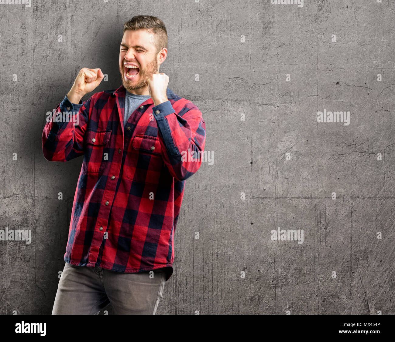 Young handsome man happy and excited expressing winning gesture ...