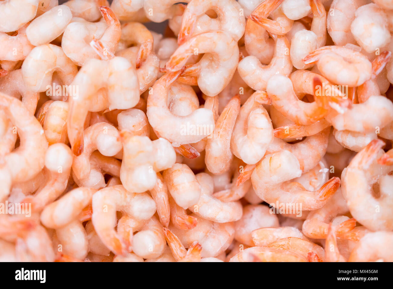 Frozen peeled shrimps. background Stock Photo - Alamy