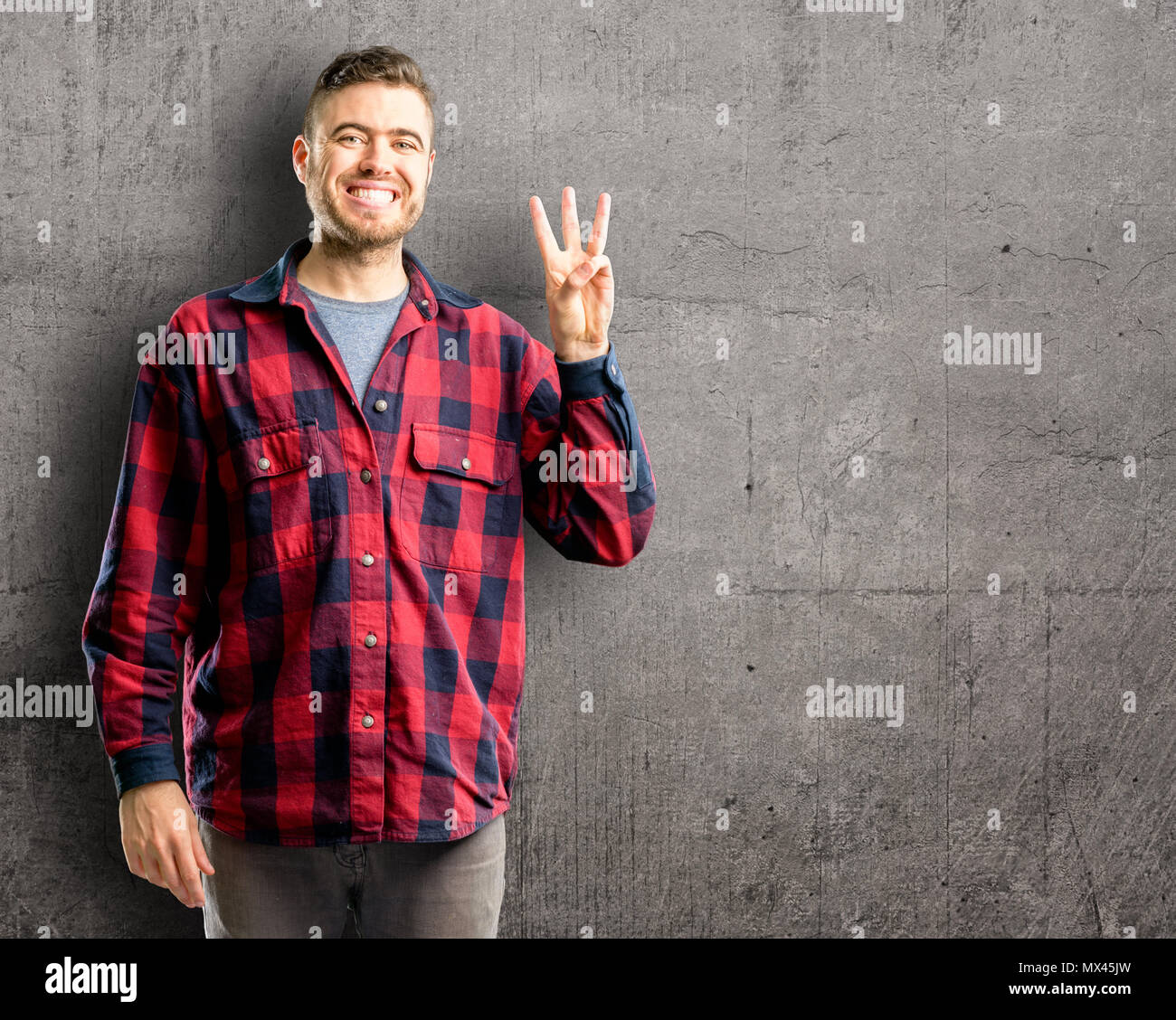Young handsome man raising his finger, is the number three Stock Photo ...