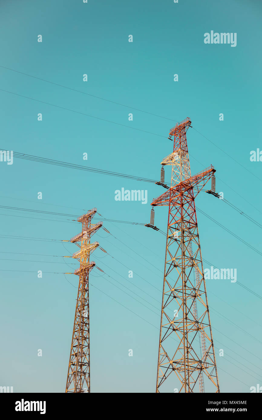 Two large rectangular high-voltage electrical transmission towers with ...