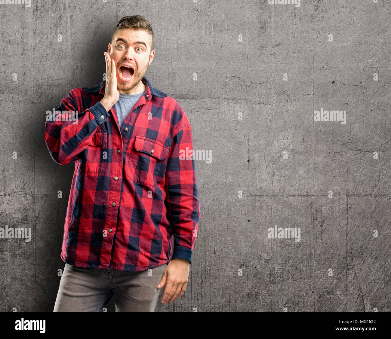 Young handsome man so happy and confident showing a big smile surprised ...