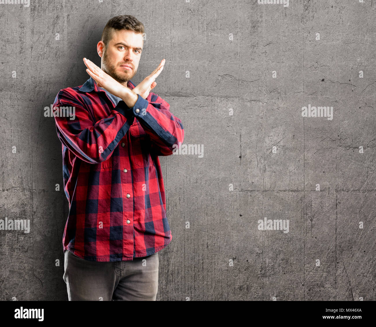 Young handsome man annoyed with bad attitude making stop sign crossing ...