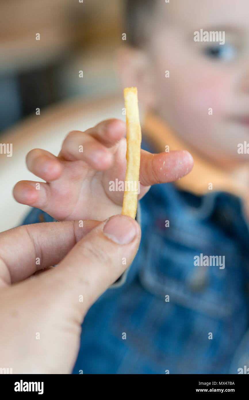 Child eating sausage fries hi-res stock photography and images - Alamy