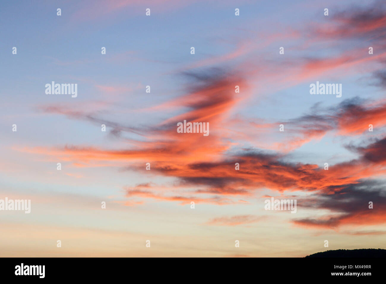 Dramatic multi-coloured sky above silhouetted hills in the Addo ...