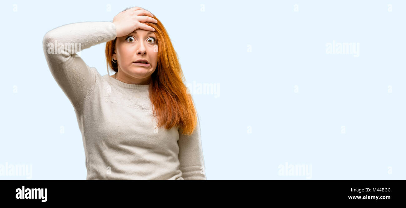 Beautiful young redhead woman terrified and nervous expressing anxiety ...