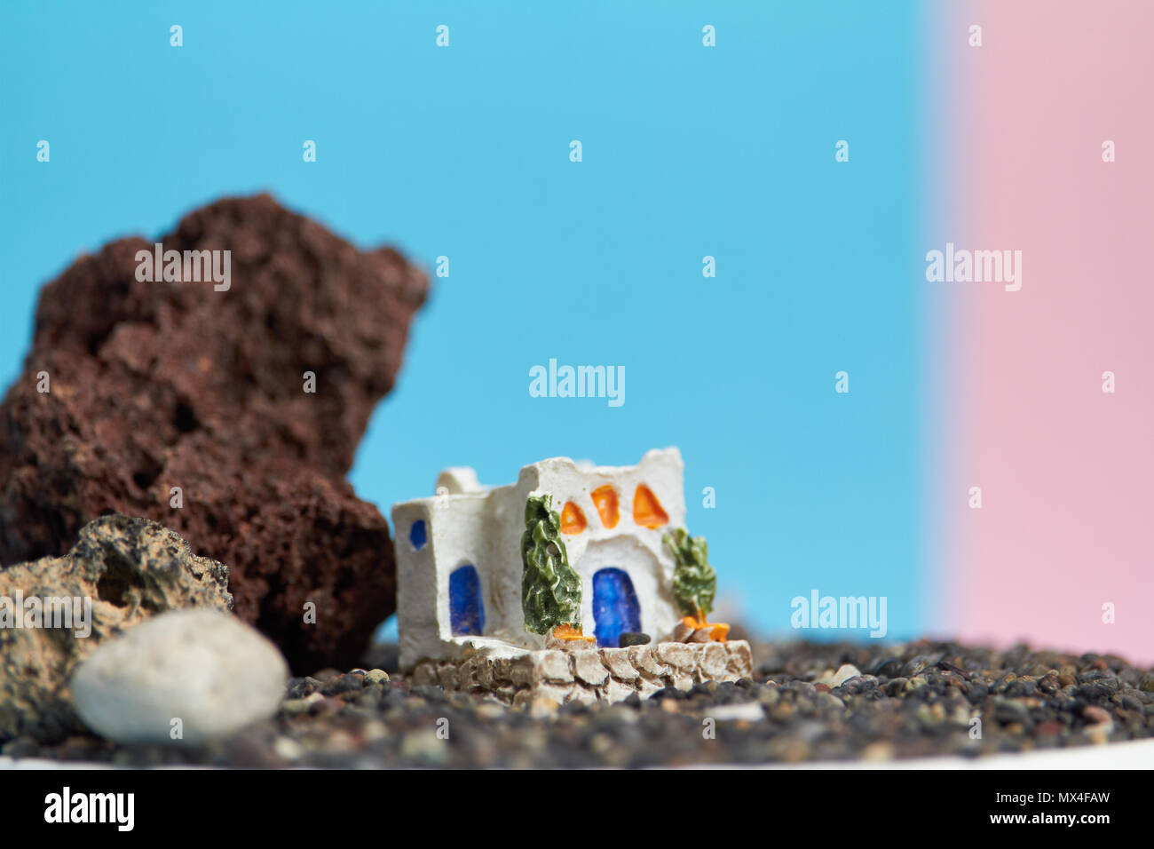 Animated model of a Greek house on a rock on a neon and pink background ...