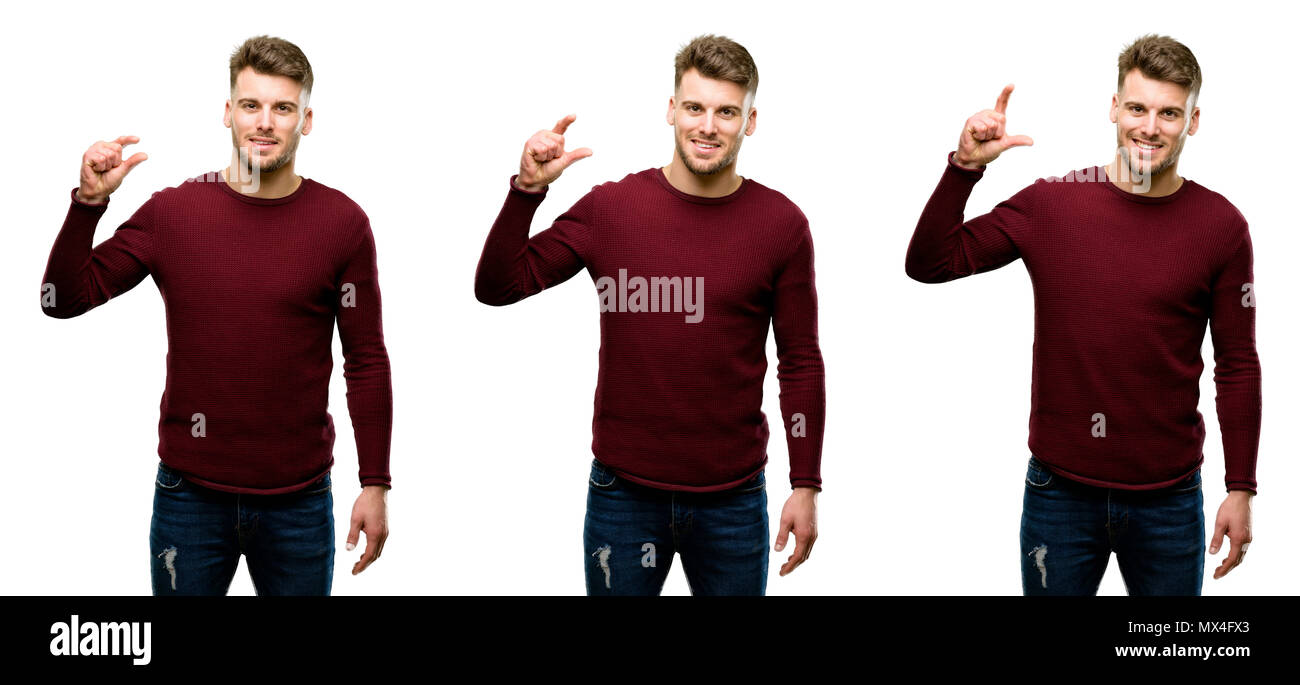 Handsome blond man holding something very tiny, size concept isolated ...
