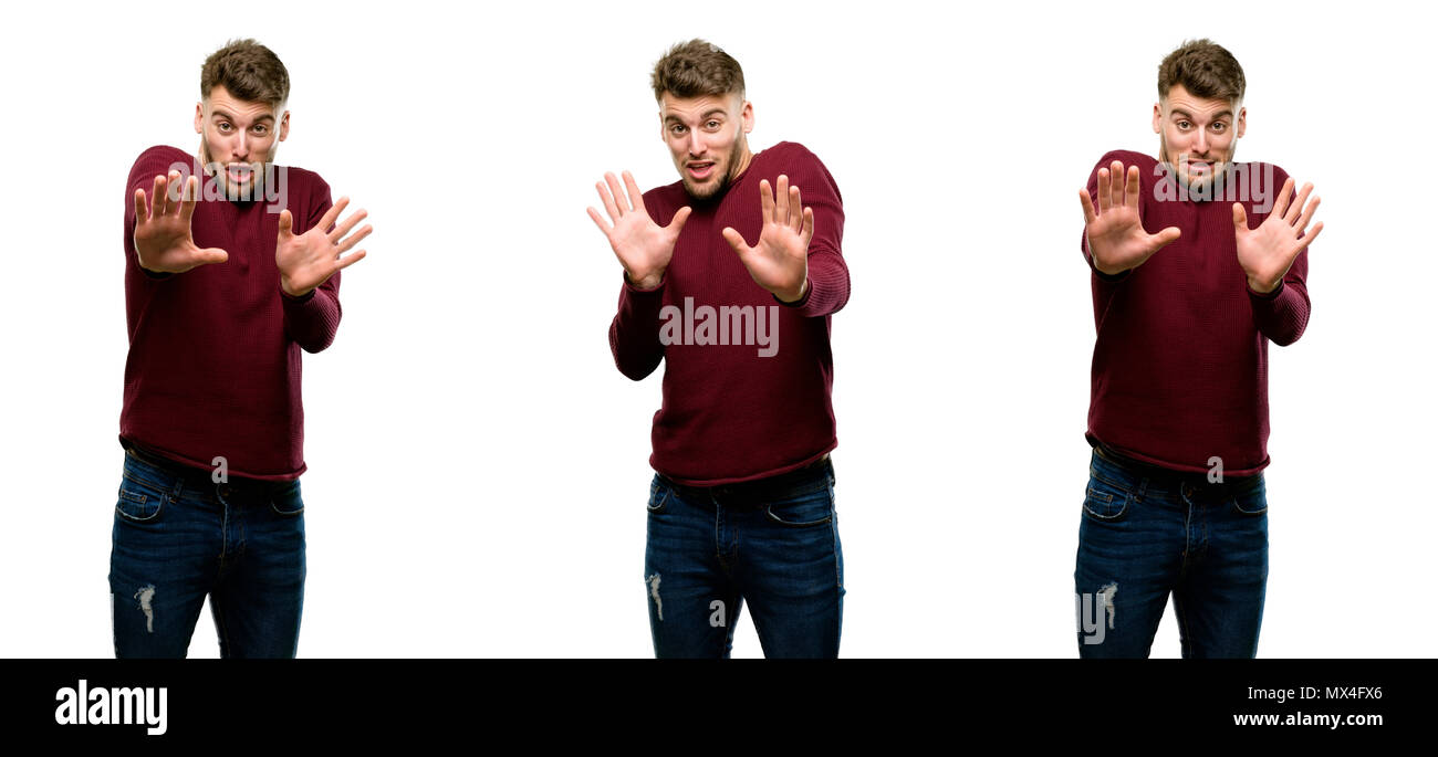 Handsome blond man disgusted and angry, keeping hands in stop gesture ...