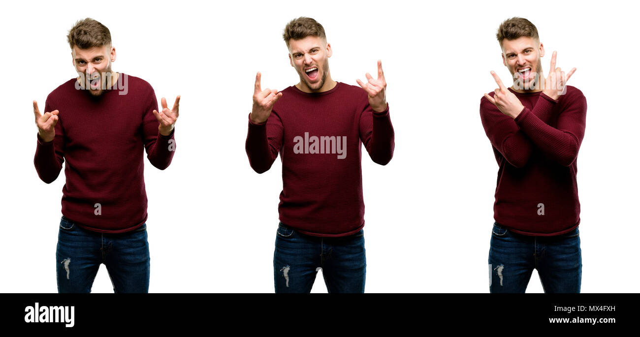 Handsome blond man making rock symbol with hands, shouting and ...