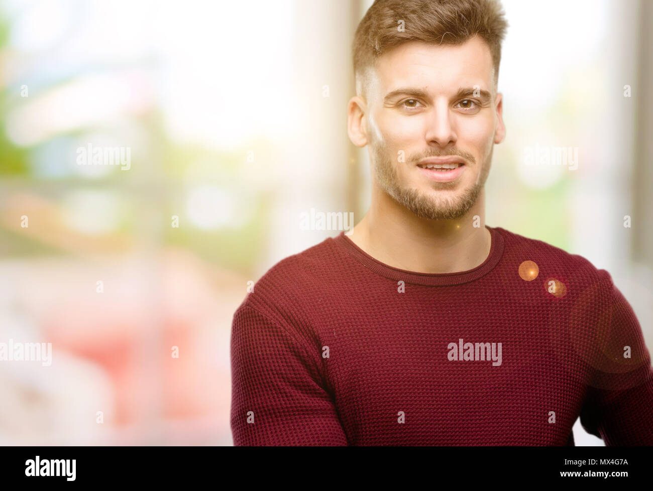 Handsome young man holding something in his empty hand Stock Photo - Alamy