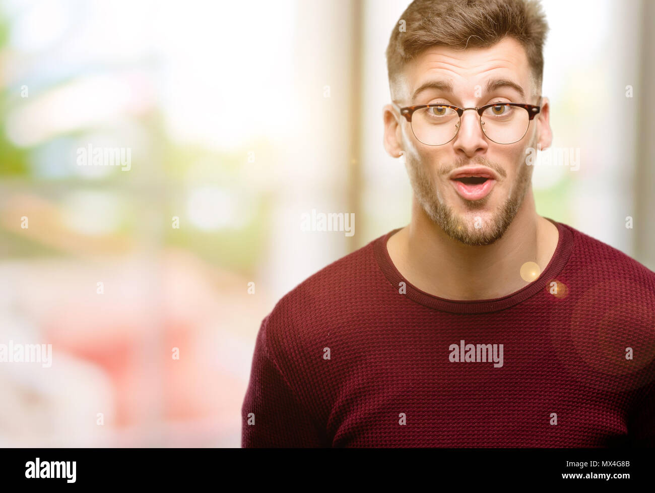 Handsome young man scared in shock, expressing panic and fear Stock ...