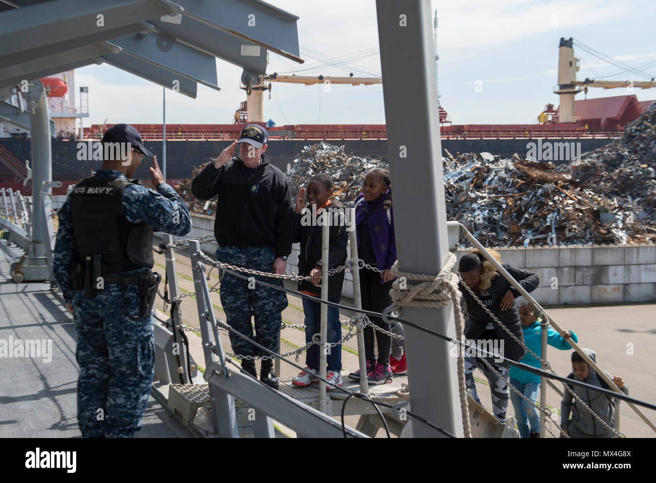 (April 30, 2017) - Ensign Logan O'Shea brings children aboard the ...