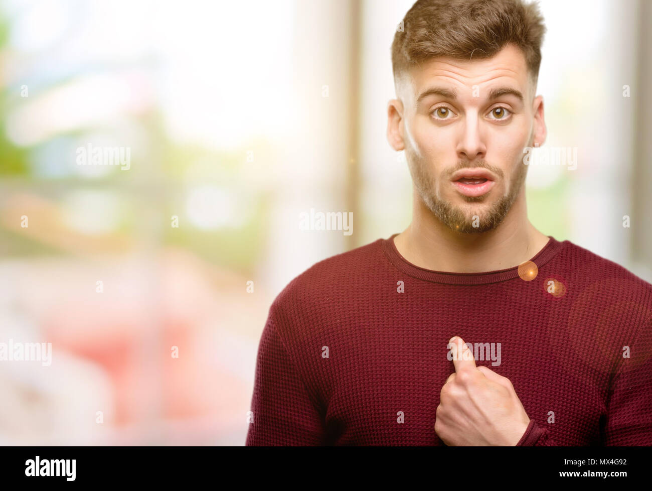 Handsome young man happy and surprised cheering expressing wow gesture ...