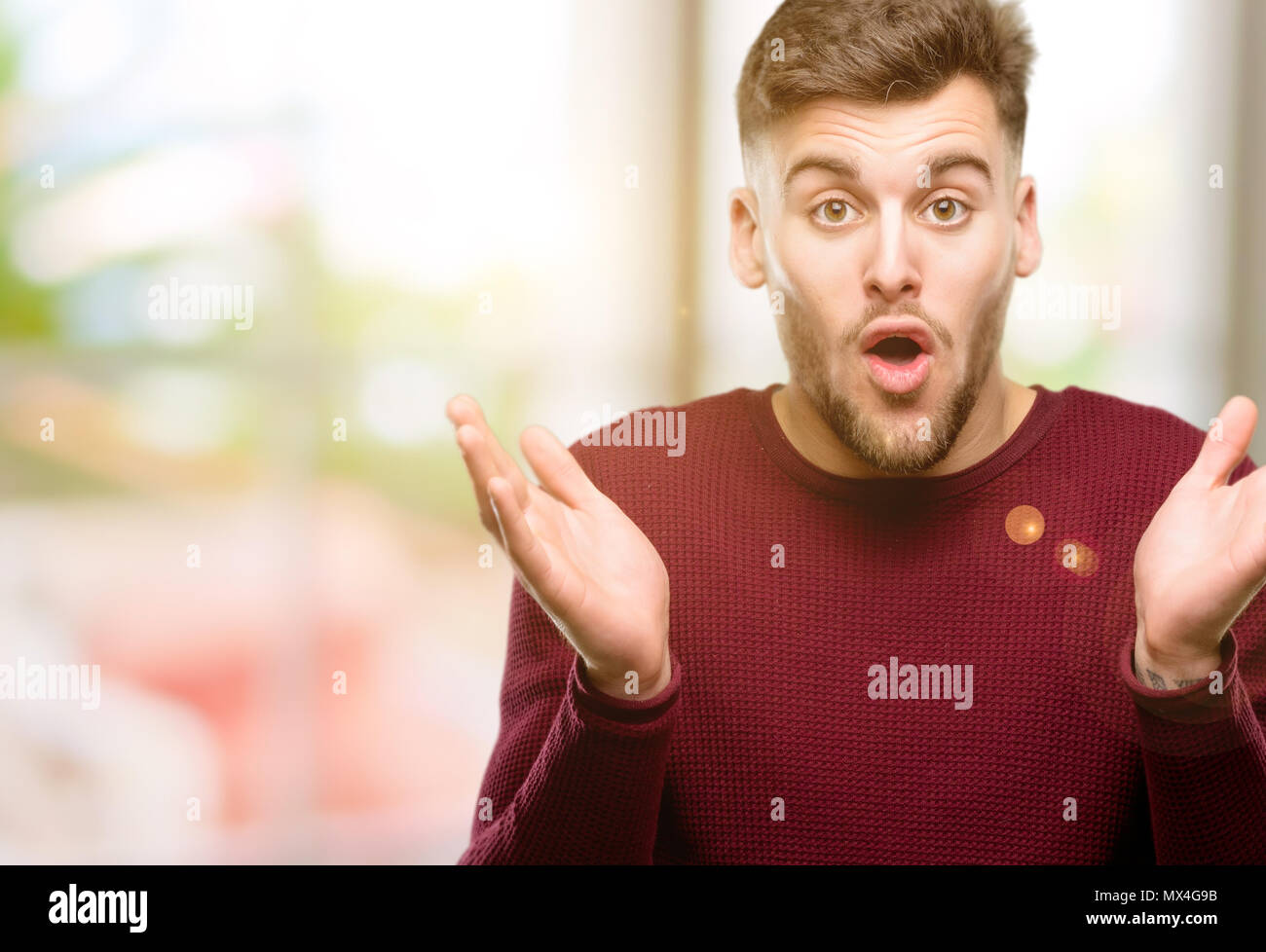 Handsome young man happy and surprised cheering expressing wow gesture ...