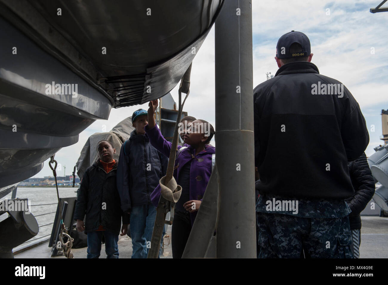 (April 30, 2017) - Ensign Logan O'Shea shows children a rigid-hull ...