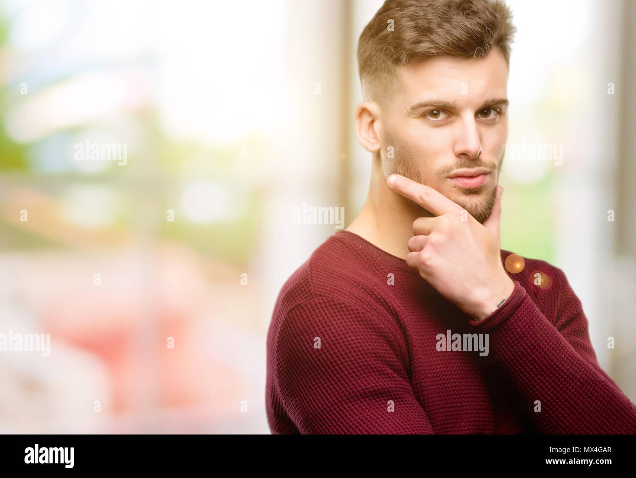 Handsome young man doubt expression, confuse and wonder concept ...