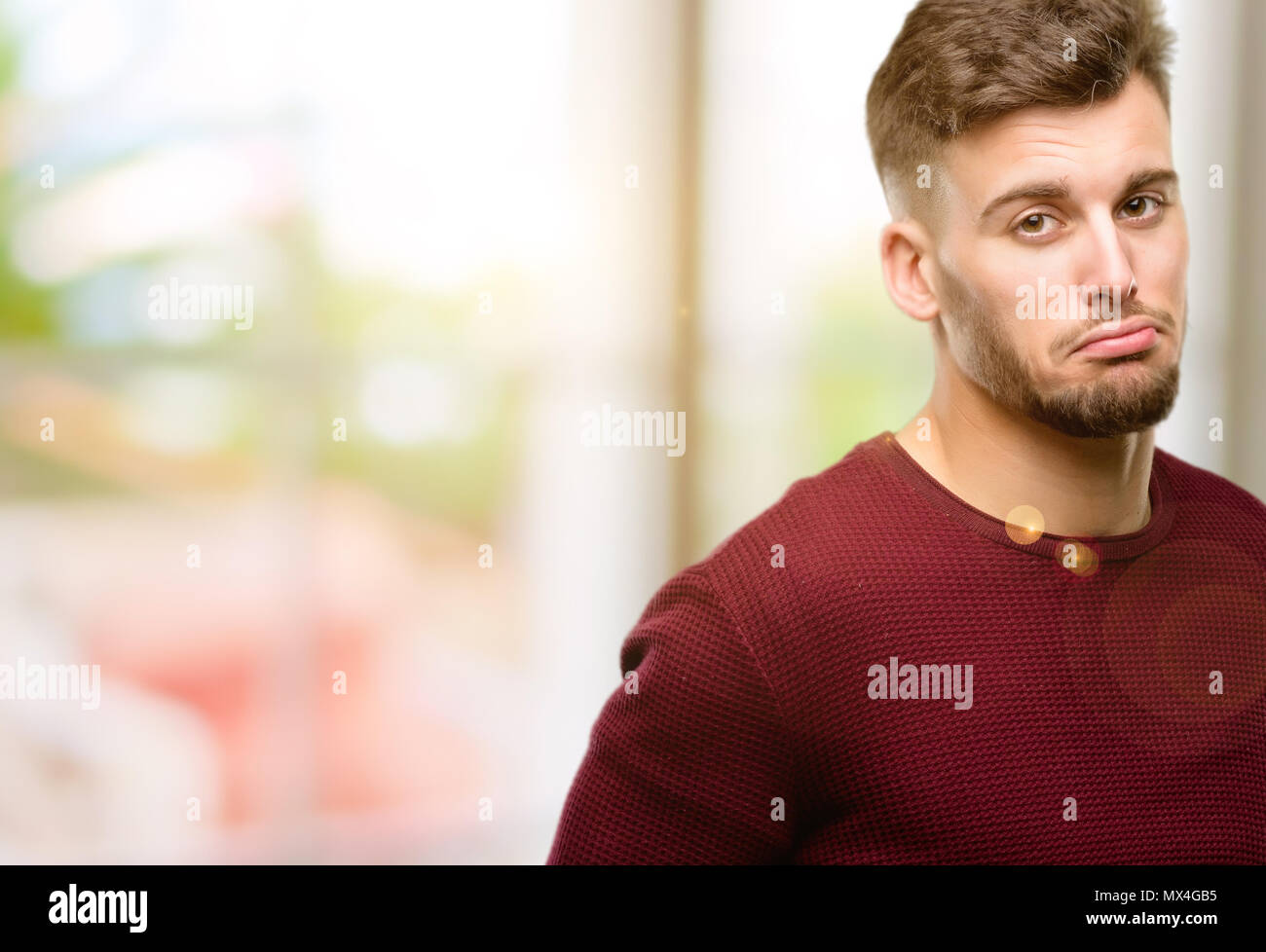 Handsome young man with sad and upset expression, unhappy Stock Photo ...
