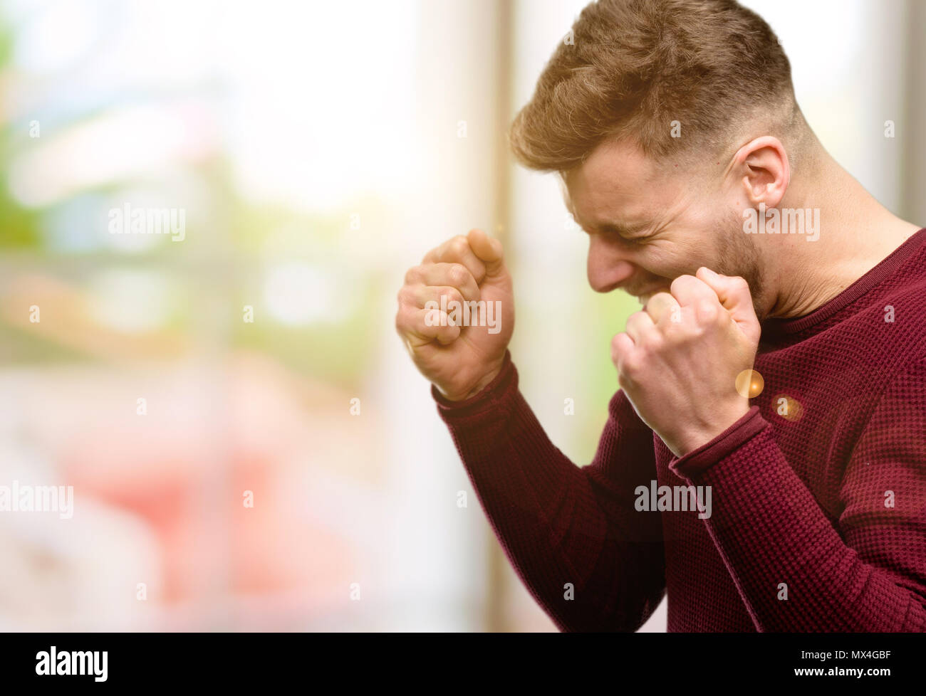 Handsome young man happy and excited expressing winning gesture ...