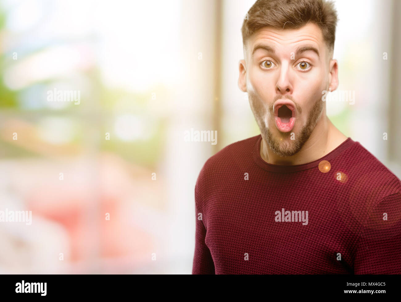 Handsome young man happy and surprised cheering expressing wow gesture ...