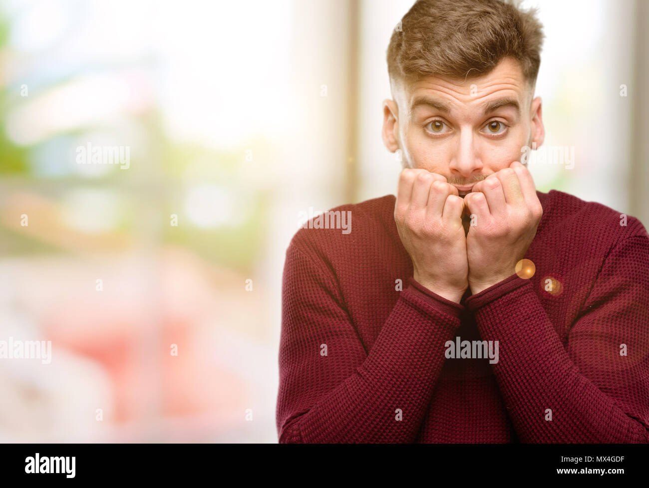 Handsome young man terrified and nervous expressing anxiety and panic ...