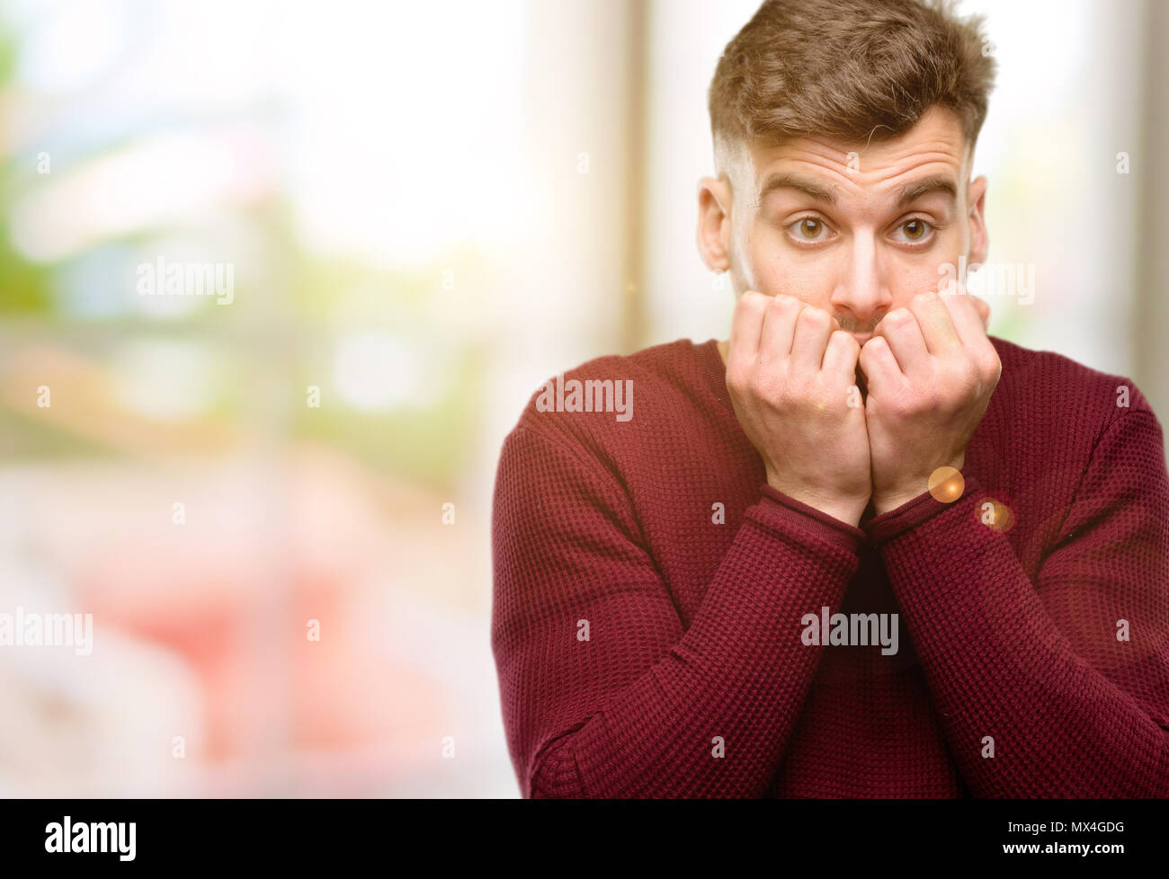 Handsome young man terrified and nervous expressing anxiety and panic ...
