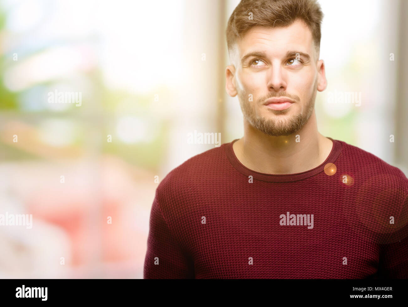 Handsome young man doubt expression, confuse and wonder concept ...