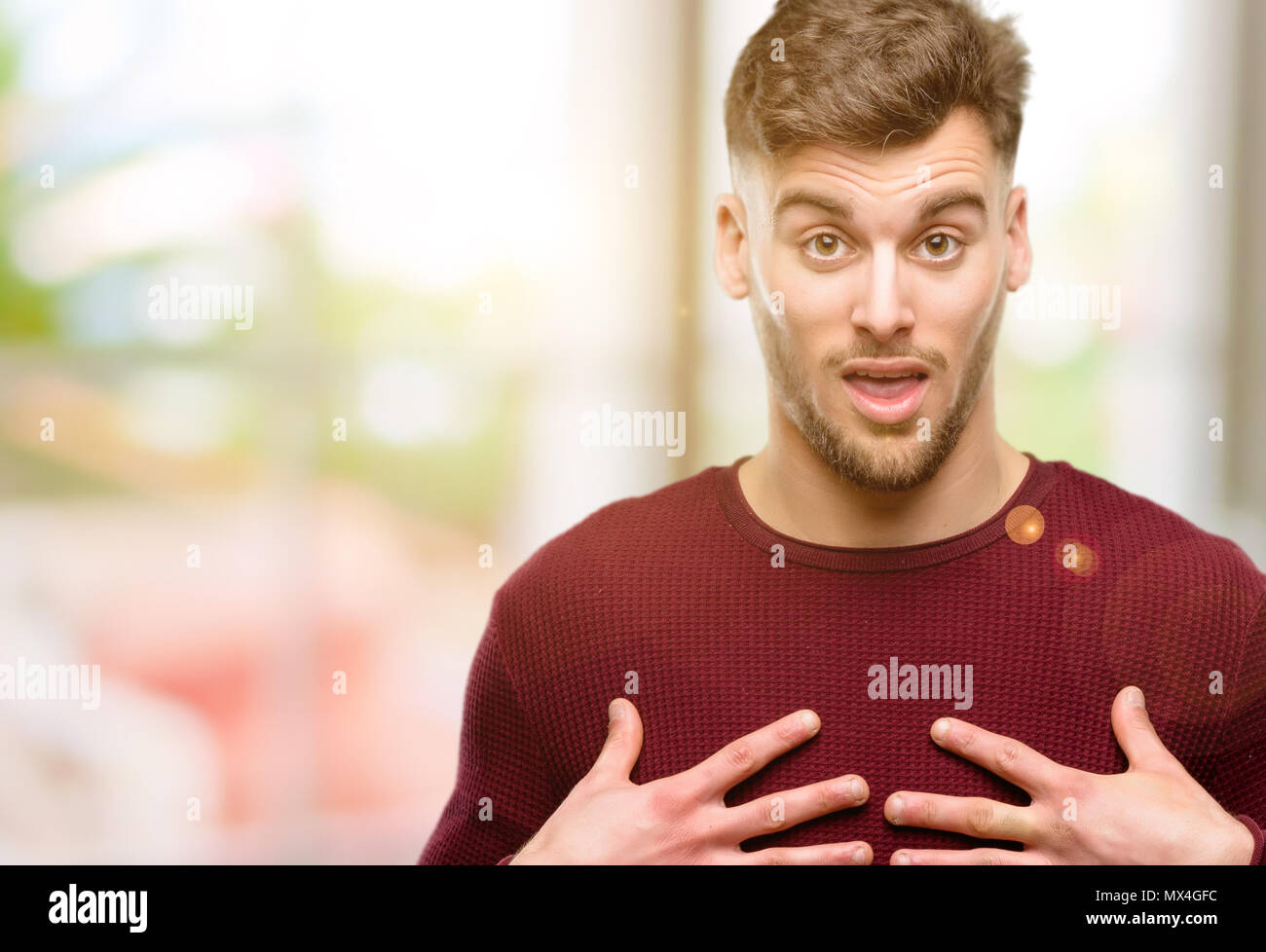 Handsome young man happy and surprised cheering expressing wow gesture ...