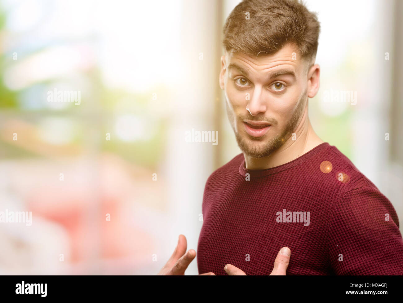 Handsome young man happy and surprised cheering expressing wow gesture ...