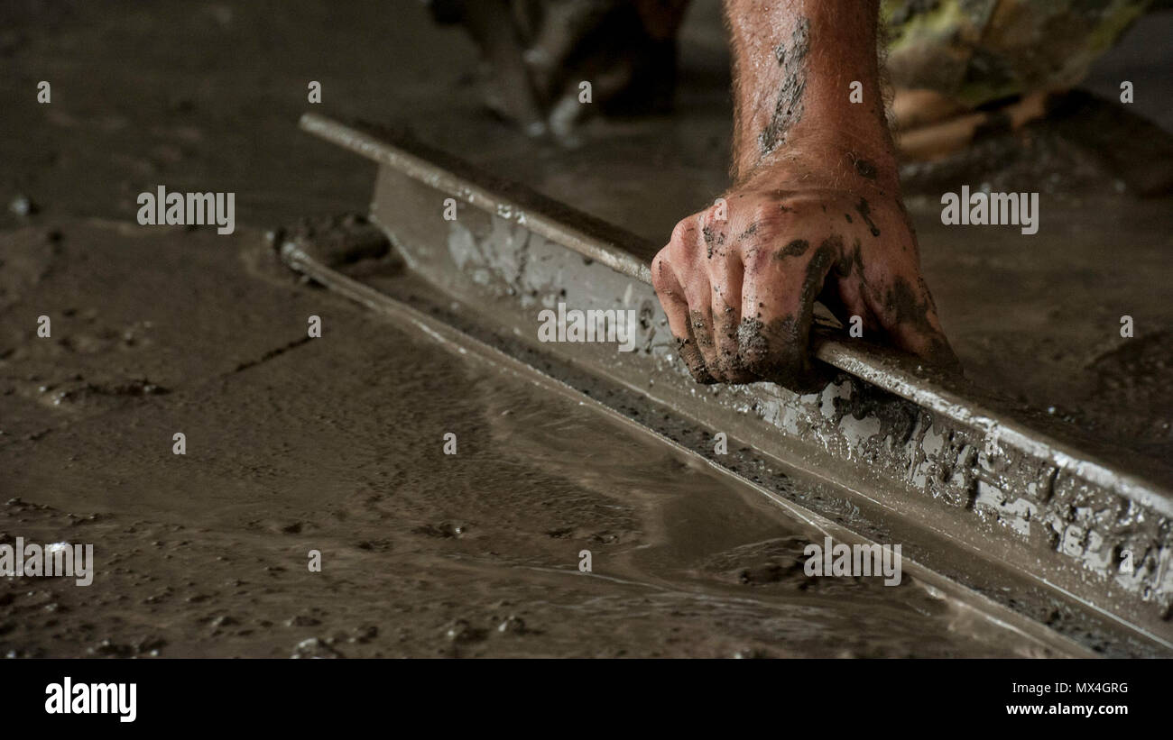 An Australian Army carpenter pours floor concrete during Balikatan 2017 ...