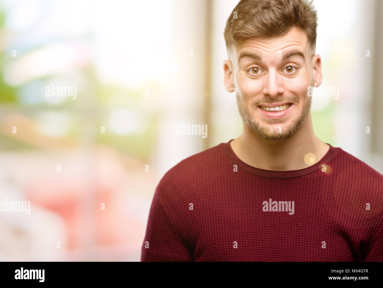 Handsome young man confident and happy with a big crazy smile laughing ...