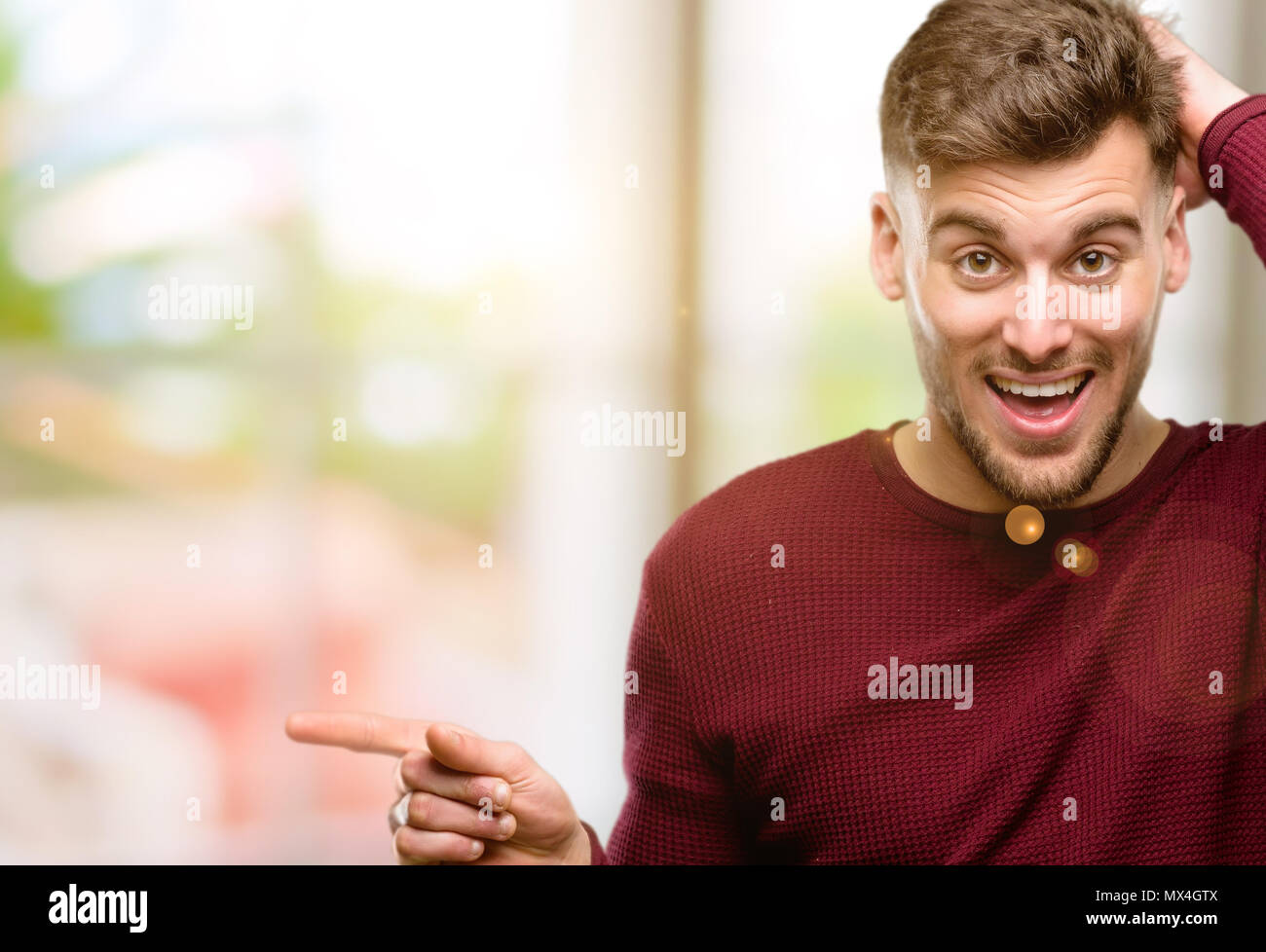 Handsome young man pointing away side with his finger Stock Photo - Alamy