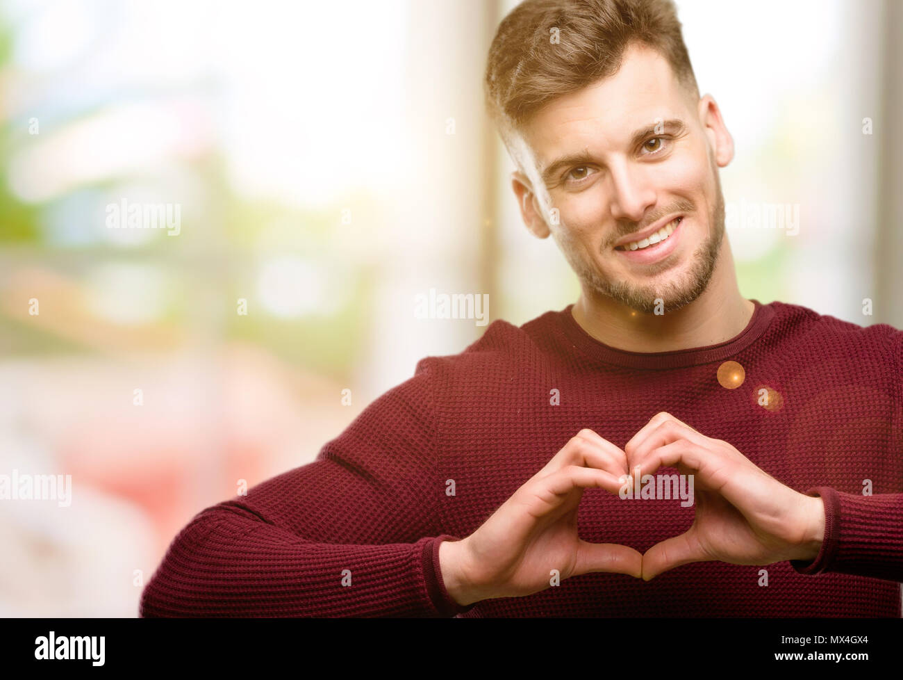 Handsome young man happy showing love with hands in heart shape ...