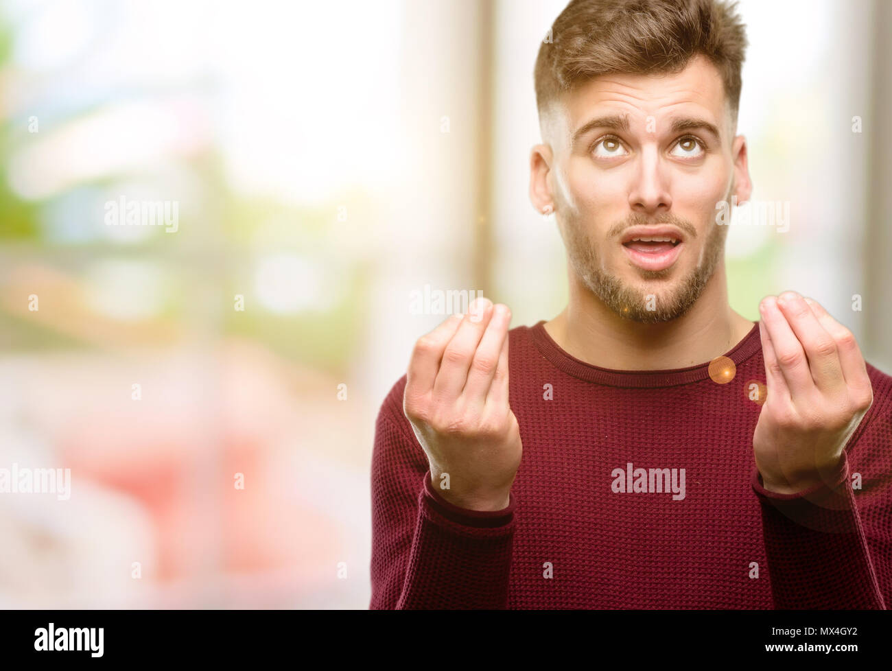 Handsome young man angry gesturing typical italian gesture with hand ...