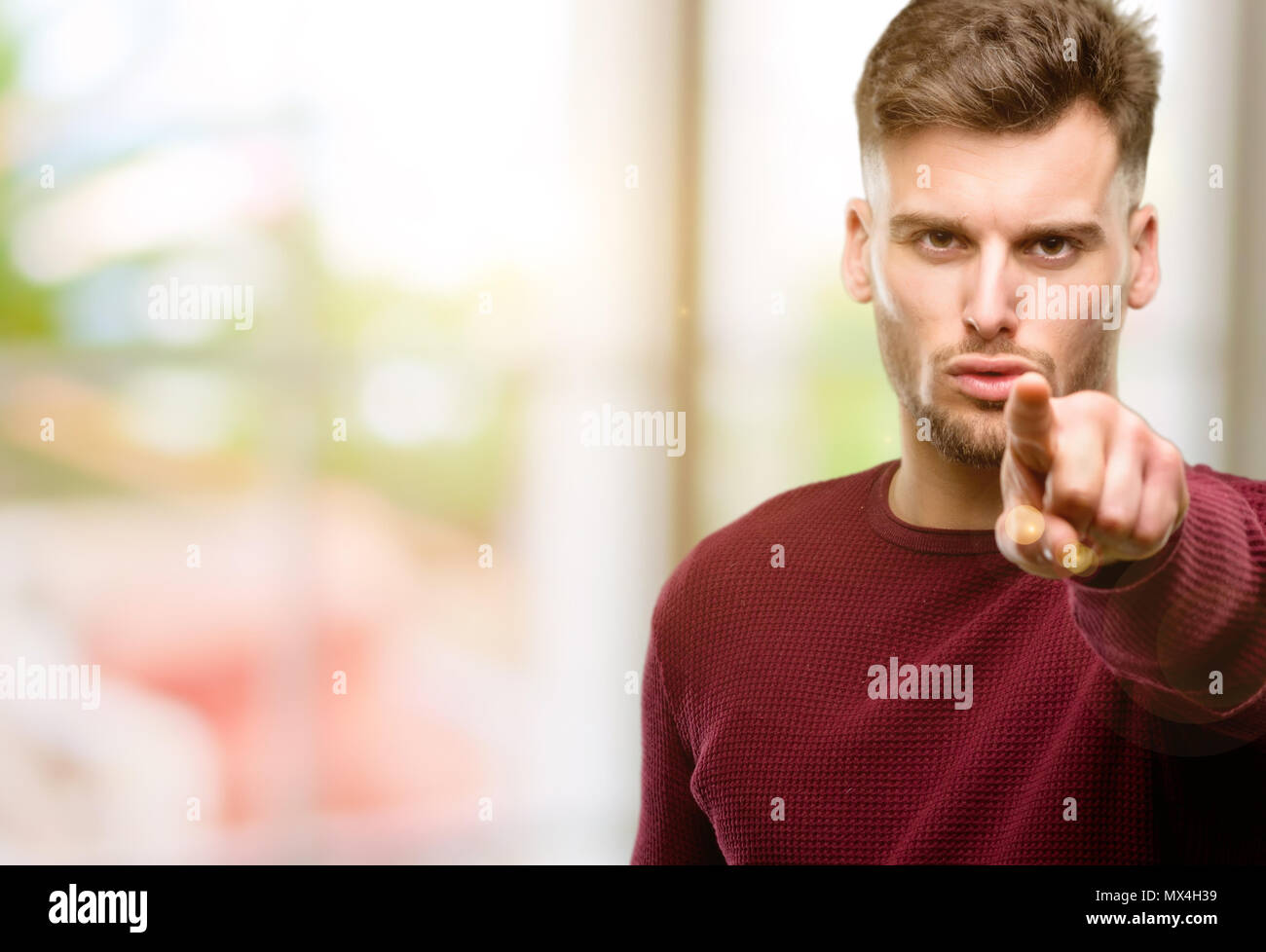 Handsome young man pointing to the front with finger Stock Photo - Alamy