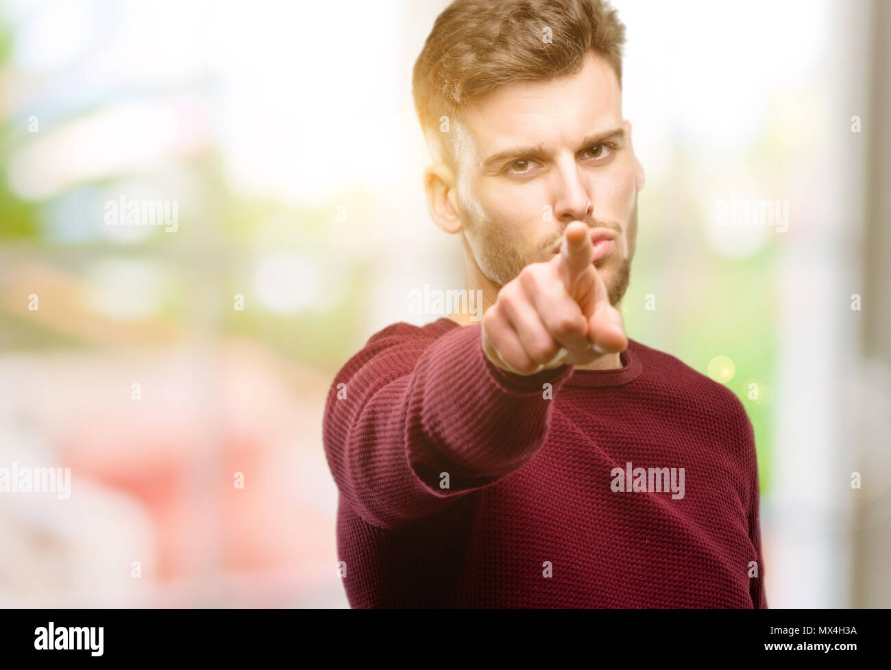 Handsome young man pointing to the front with finger Stock Photo - Alamy
