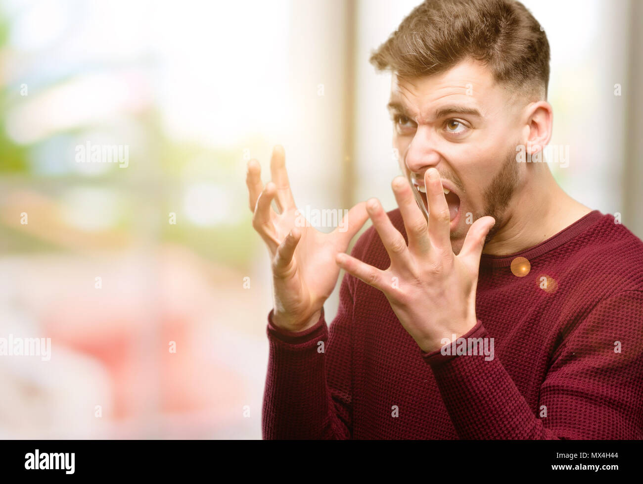 Handsome young man terrified and nervous expressing anxiety and panic ...