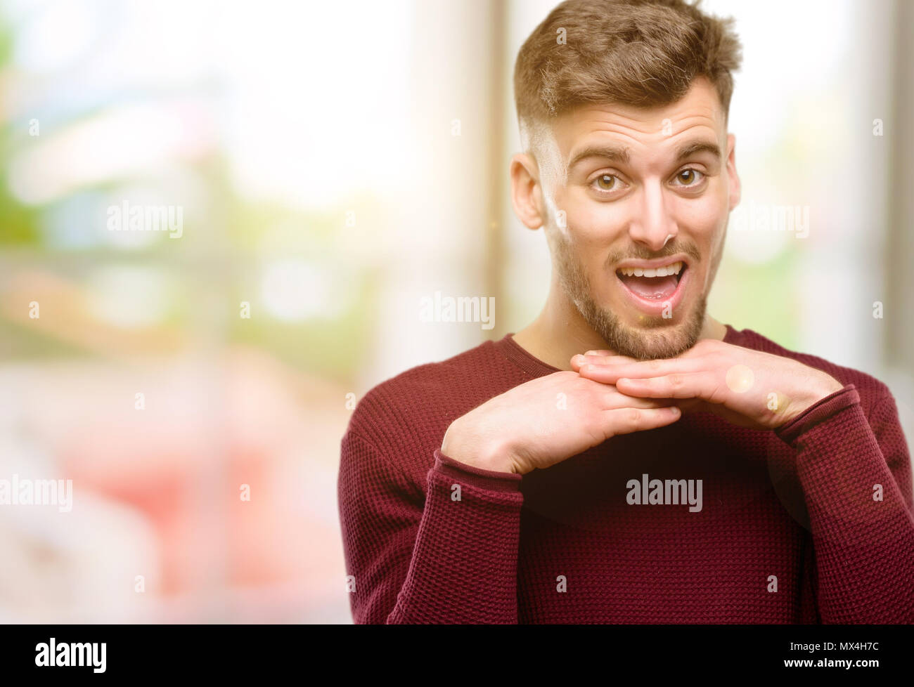 Handsome young man happy and surprised cheering expressing wow gesture ...