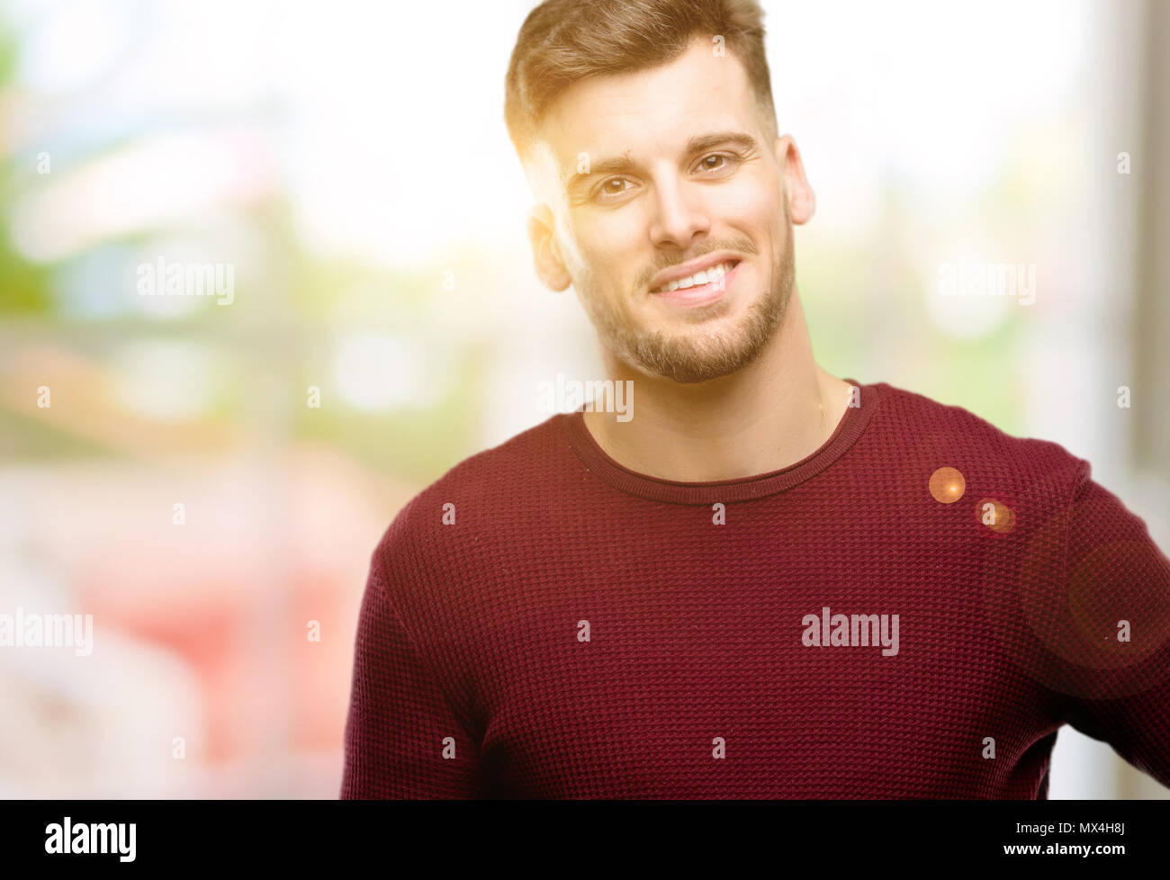 Handsome young man confident and happy with a big natural smile ...