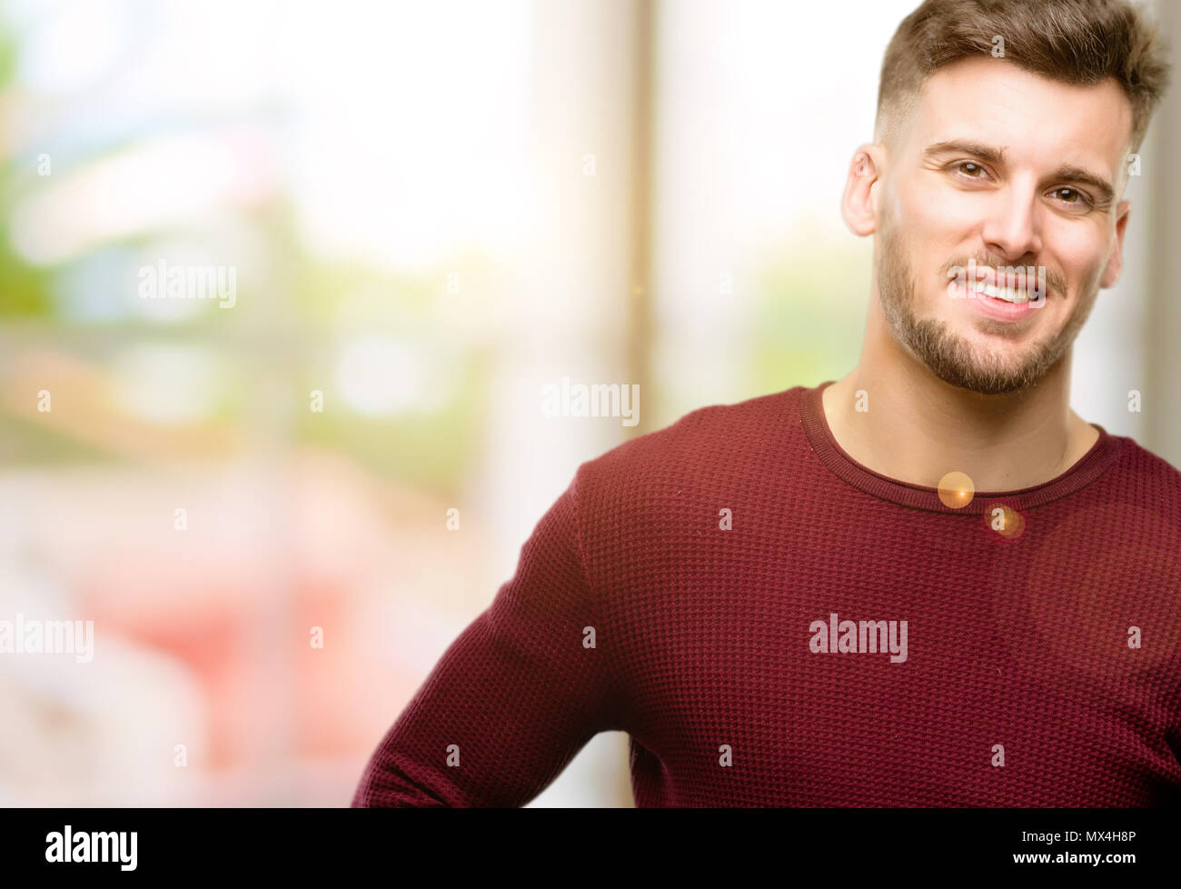 Handsome young man confident and happy with a big natural smile ...