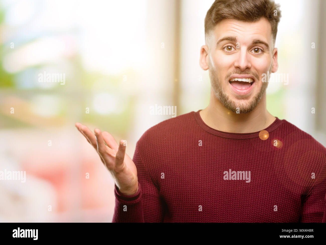 Handsome young man happy and surprised cheering expressing wow gesture ...