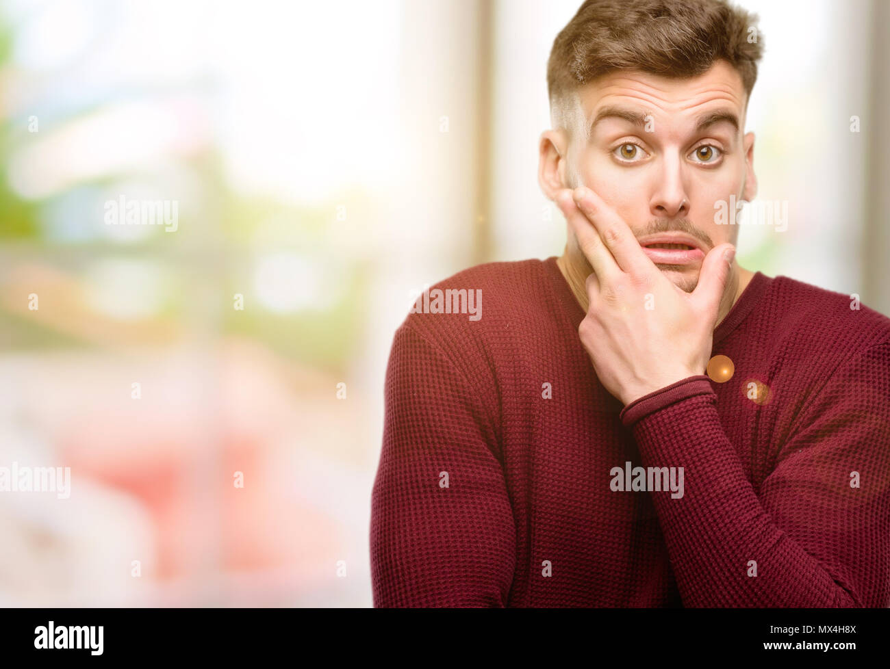 Handsome young man scared in shock, expressing panic and fear Stock ...