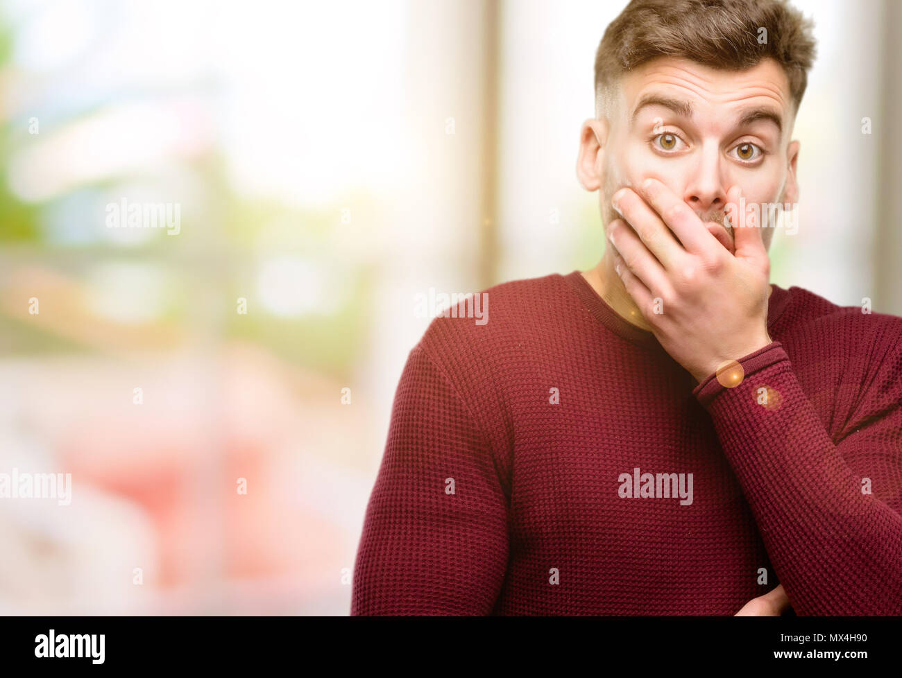 Handsome young man scared in shock, expressing panic and fear Stock ...